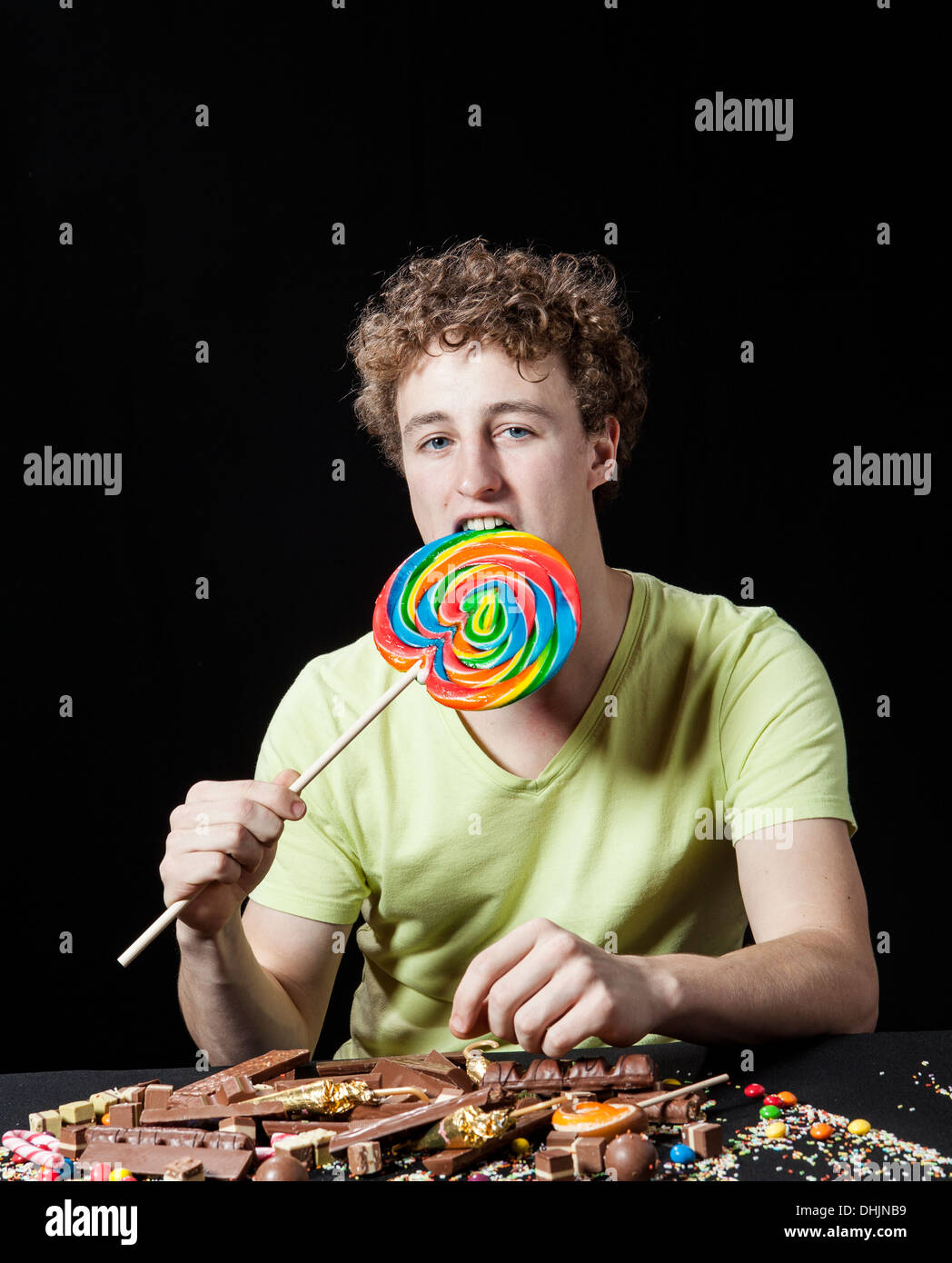 Young man with lollipop and sweets Stock Photo - Alamy