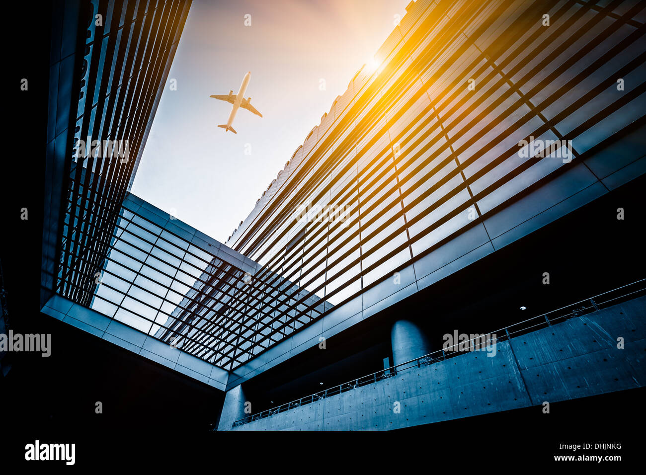 airplane fly above the airport building Stock Photo - Alamy
