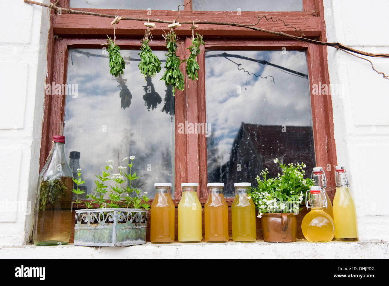 Woodruff syrup, juice and liqueur on a window sill, homemade Stock ...