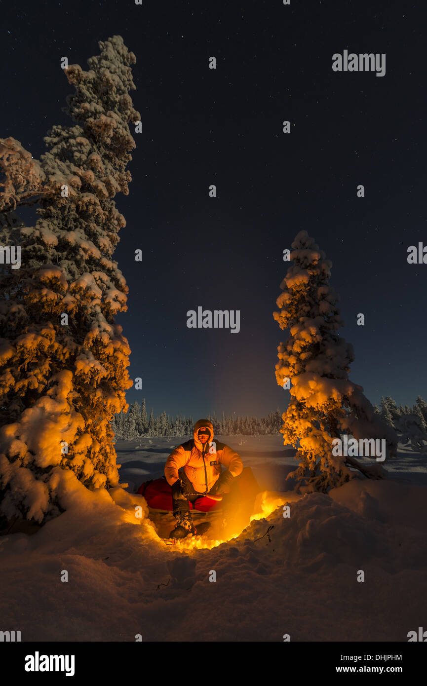 man beside a campfire in moonlight, Sweden Stock Photo - Alamy