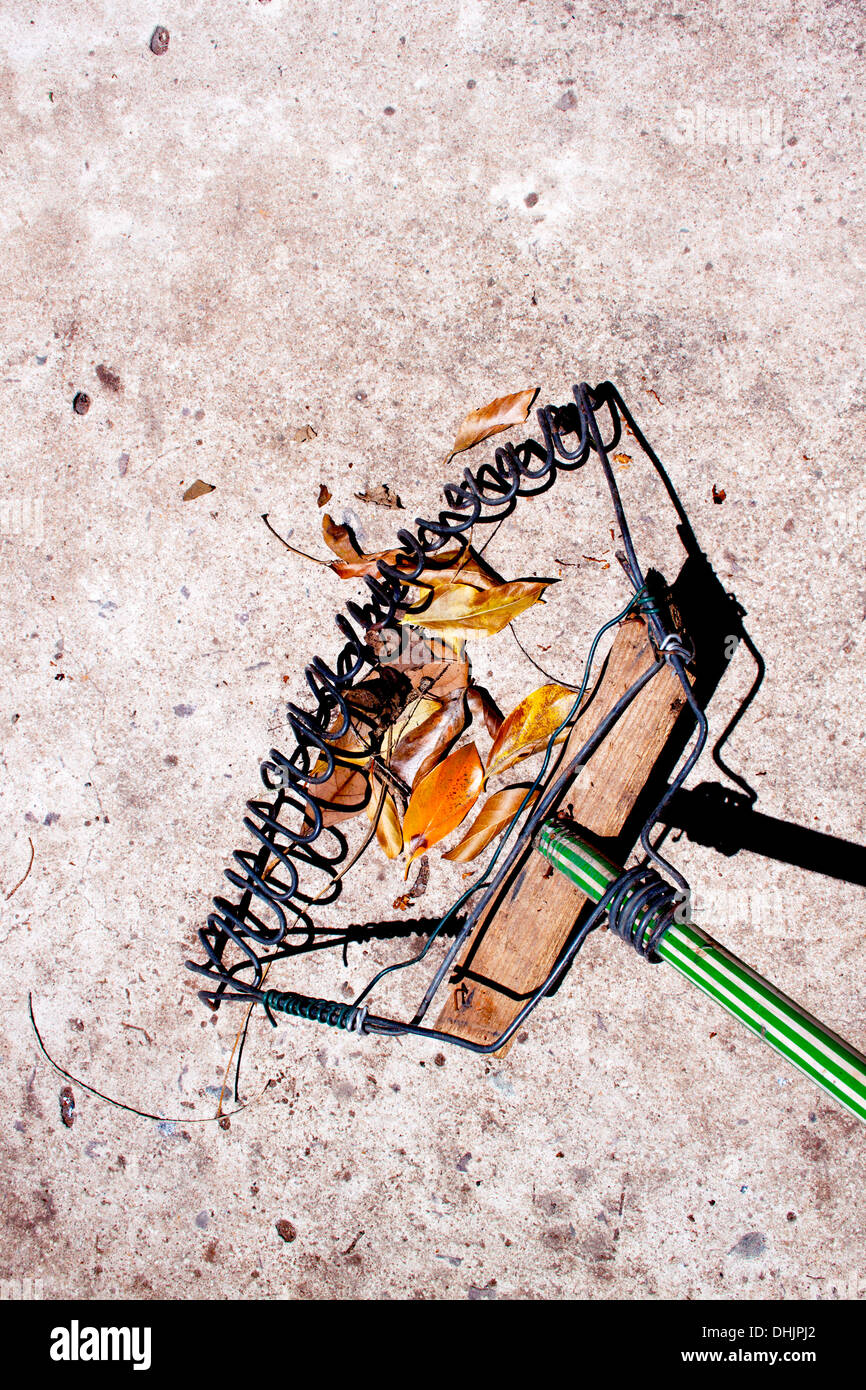 Hand made African leaf rake and leaves on concrete background Stock ...