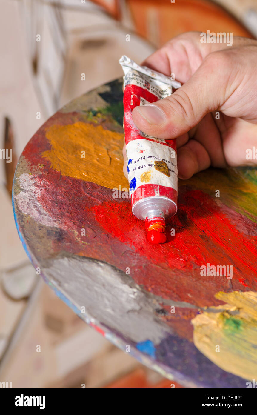 Squeezing red paint onto palette hi-res stock photography and images ...