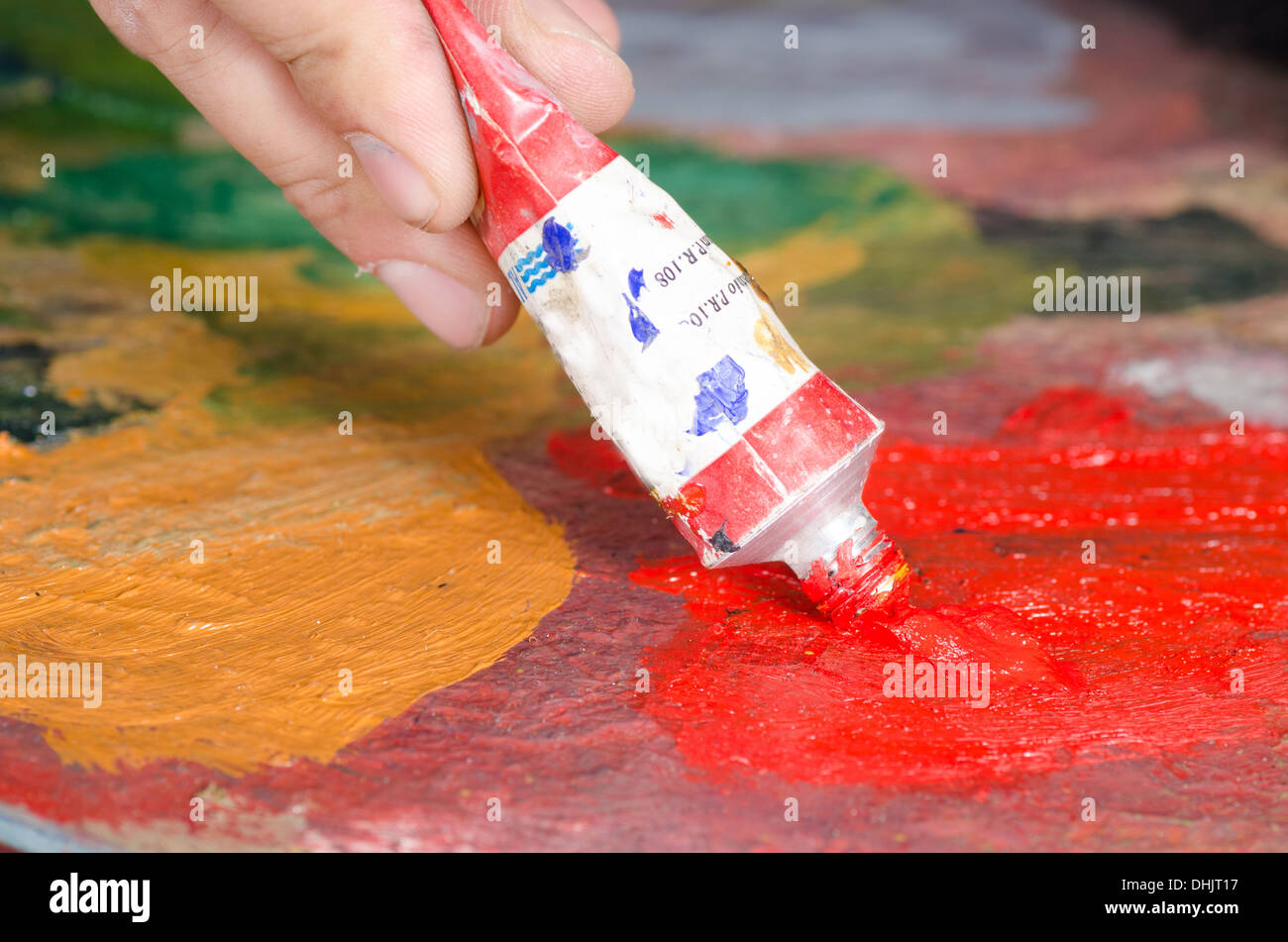 Red paint being squeezed onto a palette Stock Photo - Alamy