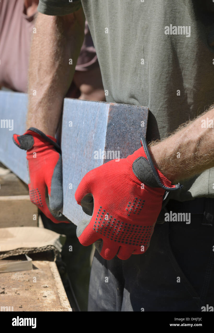 Two stonemasons working on a grave, carrying gravestone Stock Photo - Alamy