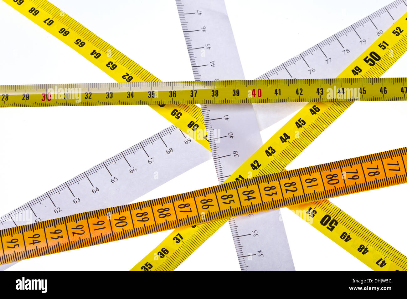 tape measures cross on white background Stock Photo - Alamy