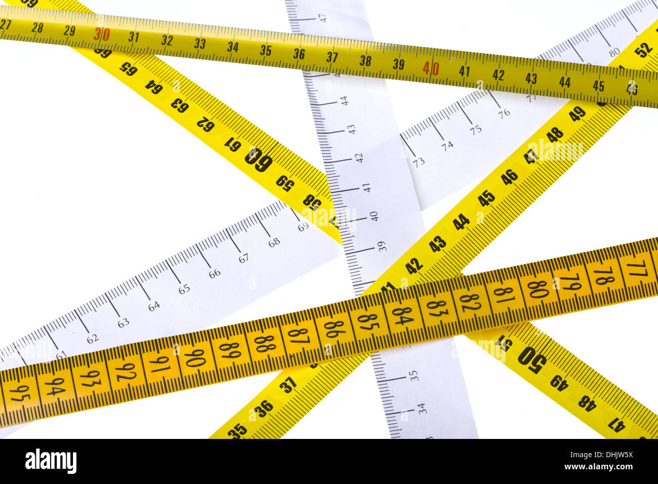 tape measures intercross on white background Stock Photo - Alamy