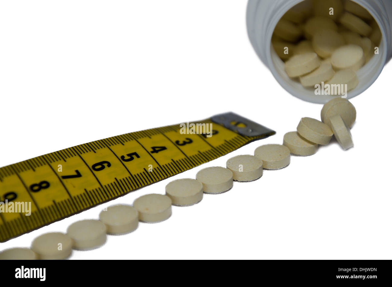 Measuring tape and pills Stock Photo - Alamy