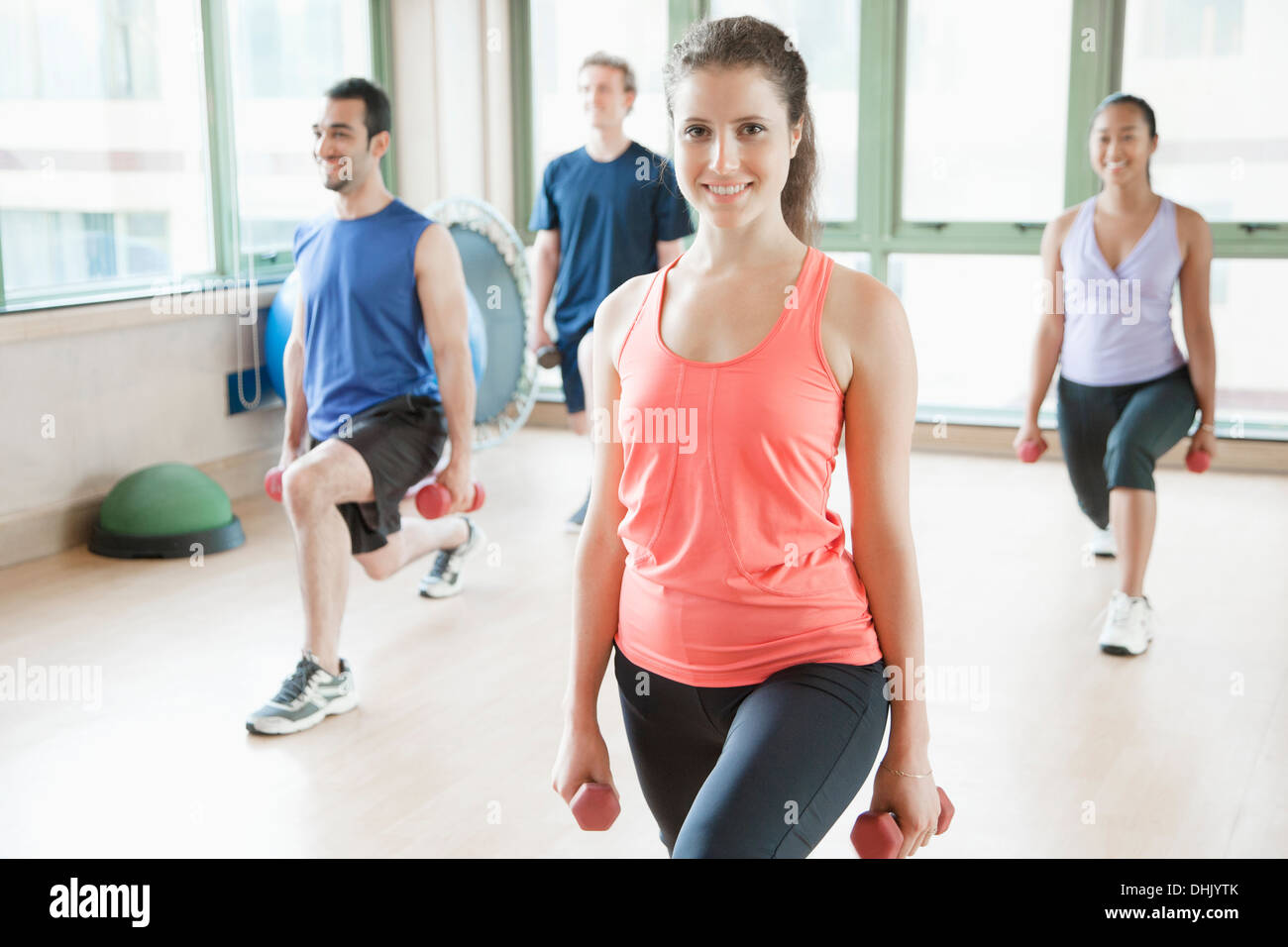 Four people stretching in aerobics class Stock Photo - Alamy