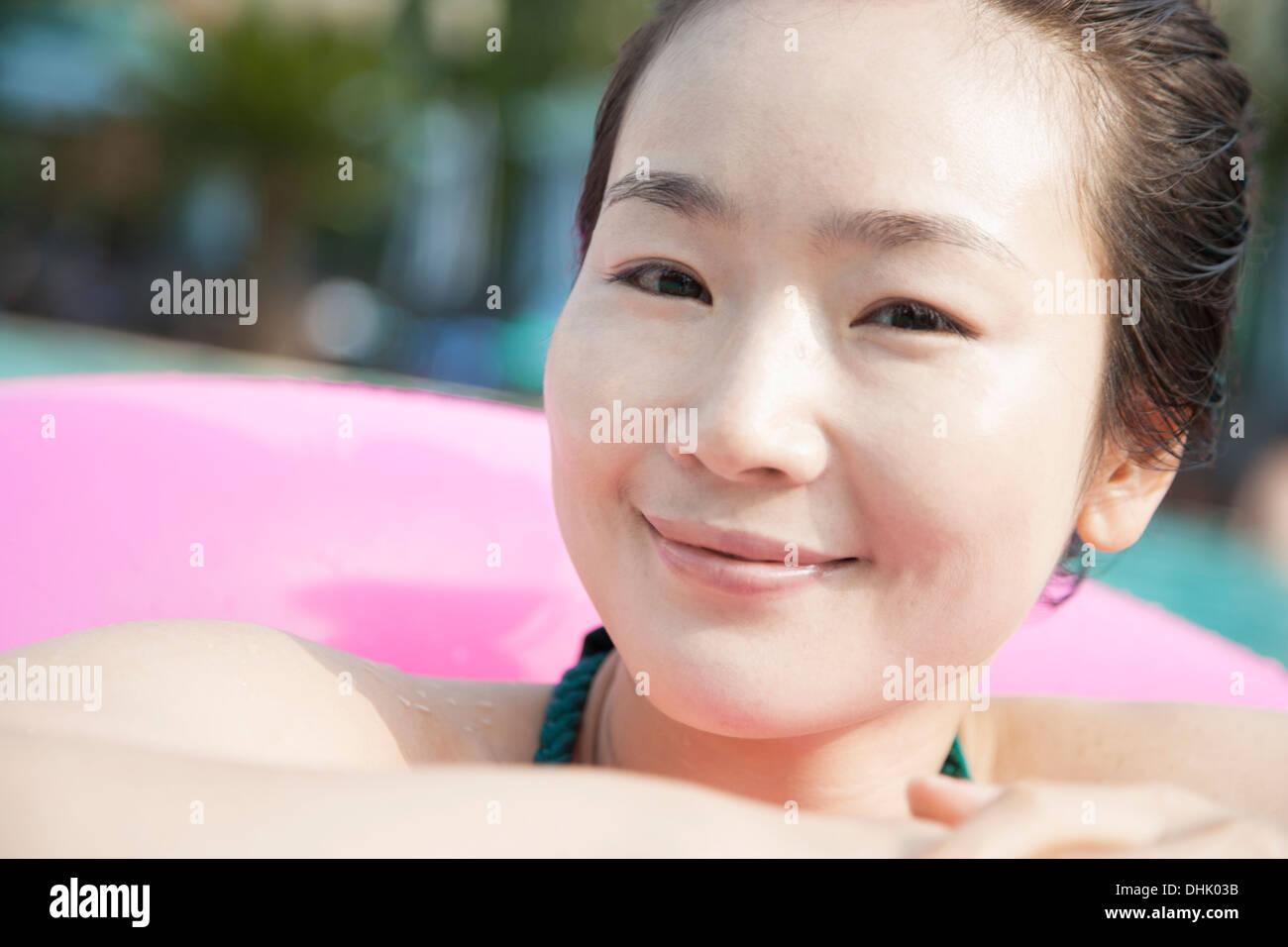 Close-Up portrait of smiling young women in the pool with an inflatable ...