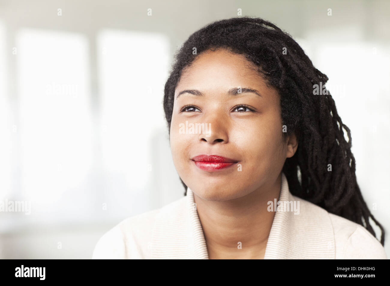 Portrait of smiling businesswoman with dreadlocks, head and shoulders ...