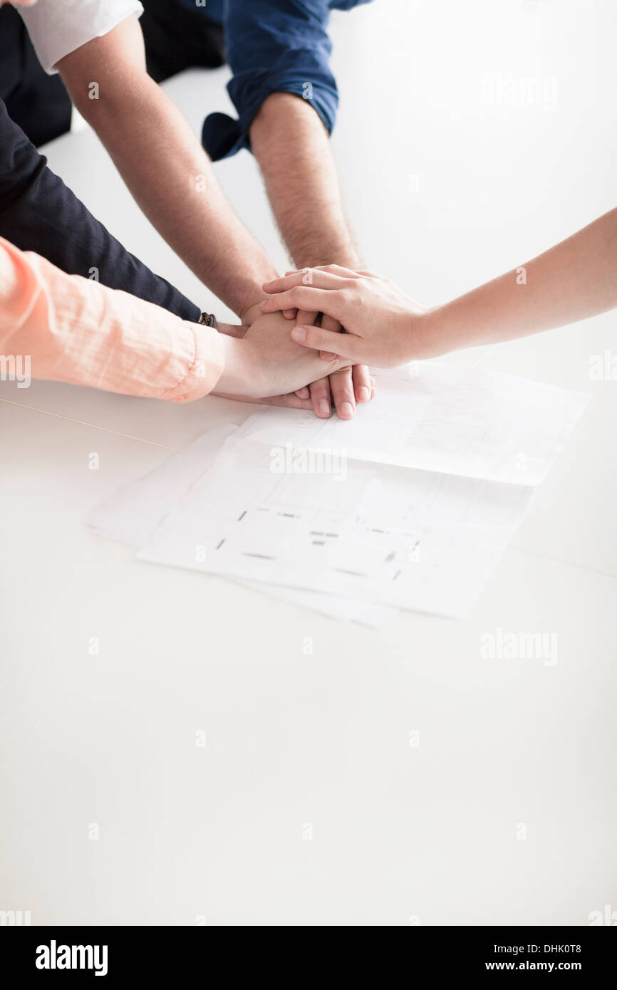 Multi race hands on top of each other hi-res stock photography and ...