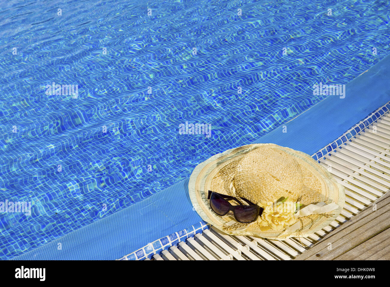 The straw hat lies on the brink of pool Stock Photo - Alamy