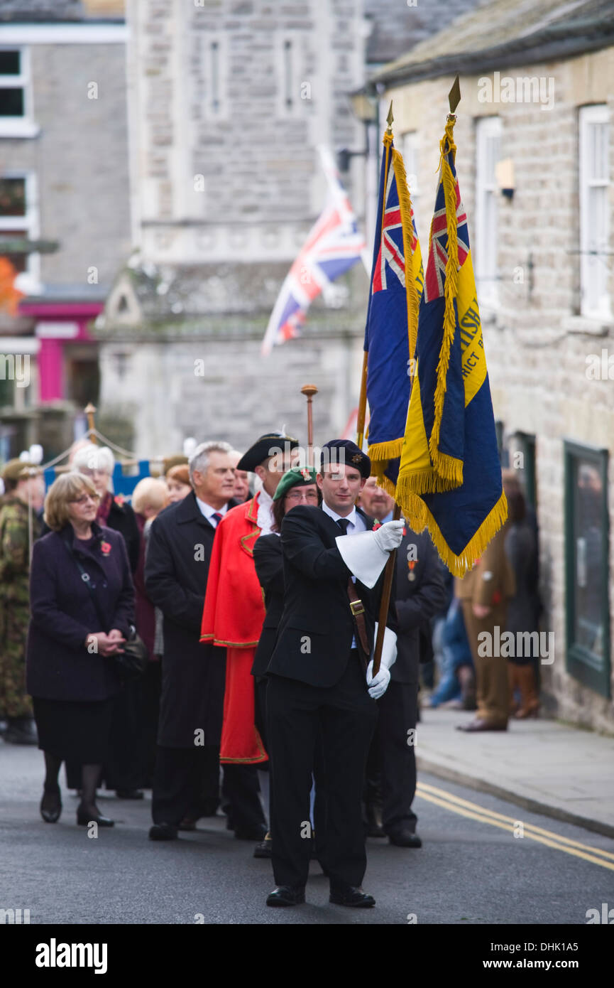 Remembrance Sunday parade with British Legion flags in front at Hay-on ...