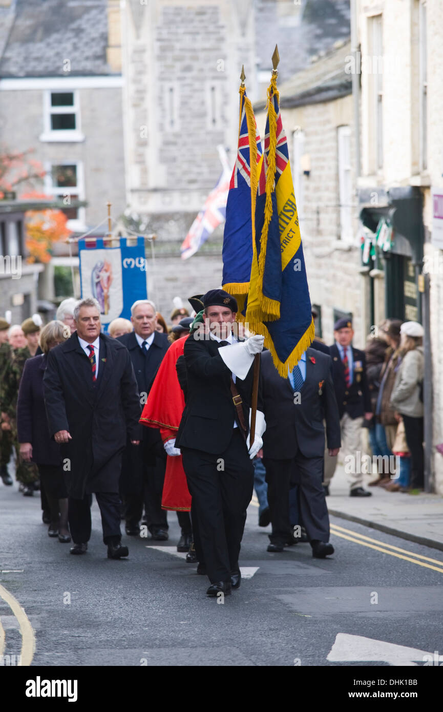 Remembrance Sunday parade with British Legion flags in front at Hay-on ...