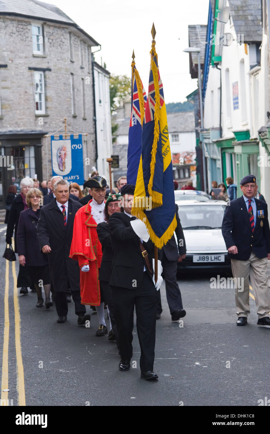 Remembrance Sunday parade with British Legion flags in front at Hay-on ...