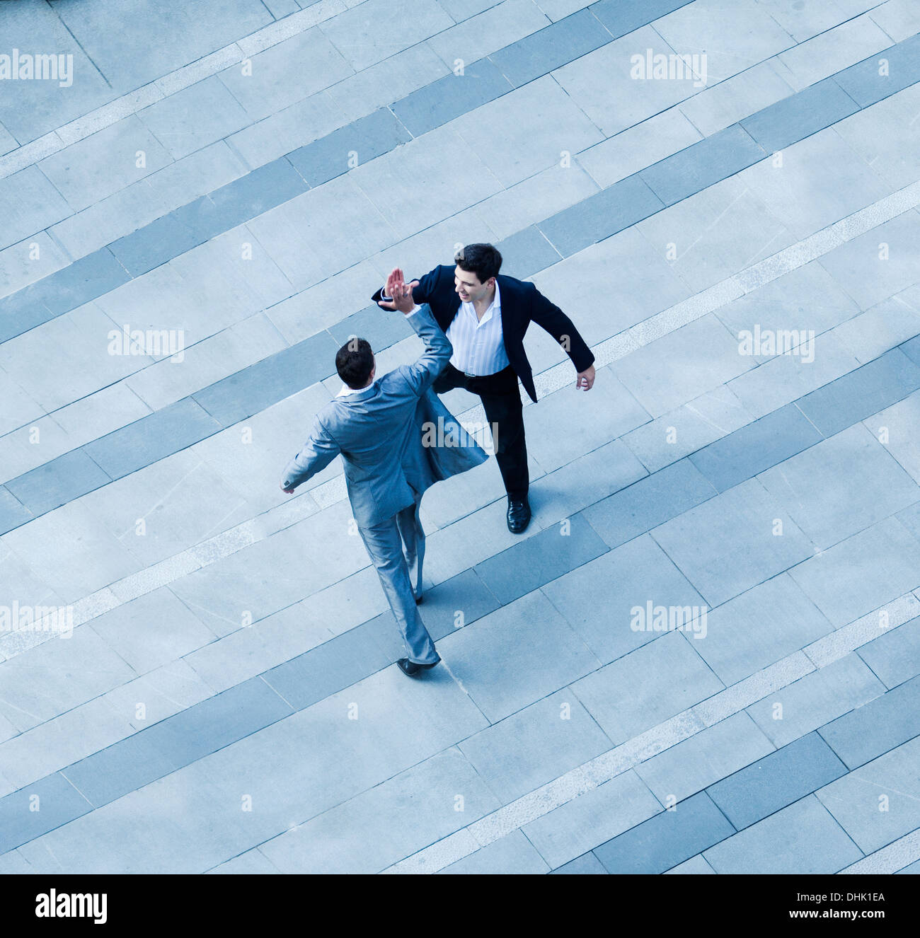 Aerial view of two businessmen giving each other a high five on the ...