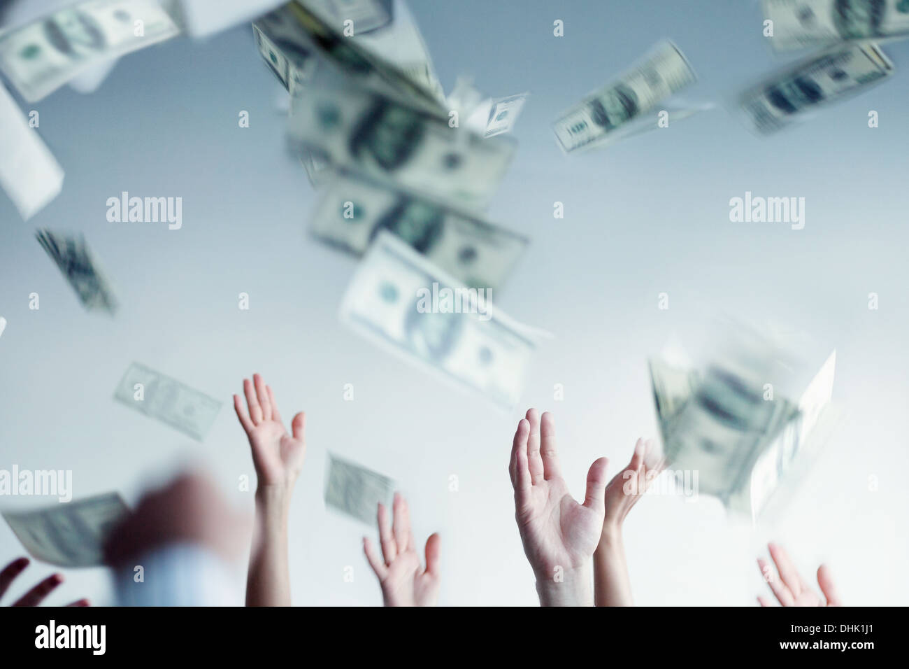 Close up on hands raised throwing and catching money in the air Stock ...