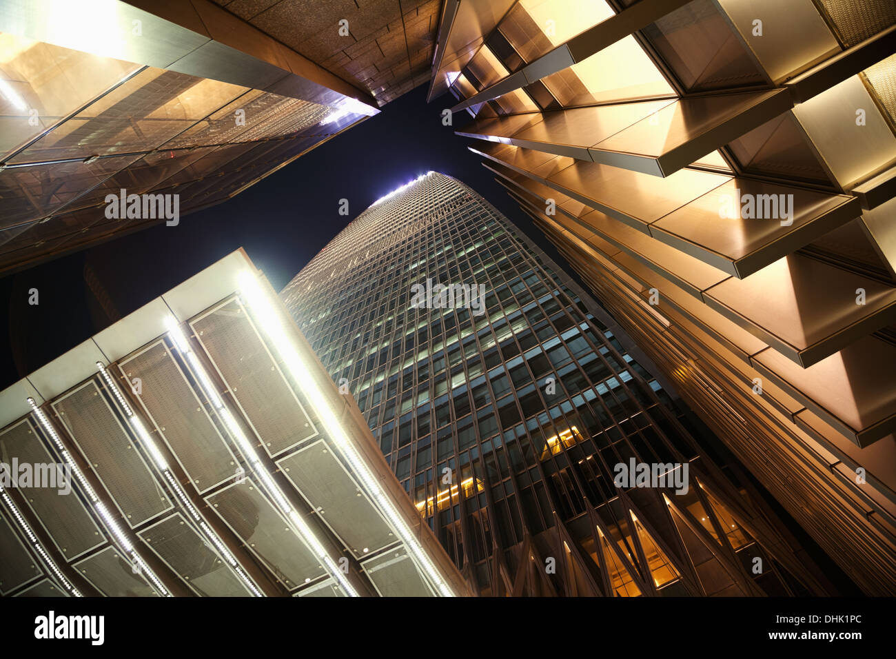 Office skyscraper, directly below, night time Stock Photo - Alamy