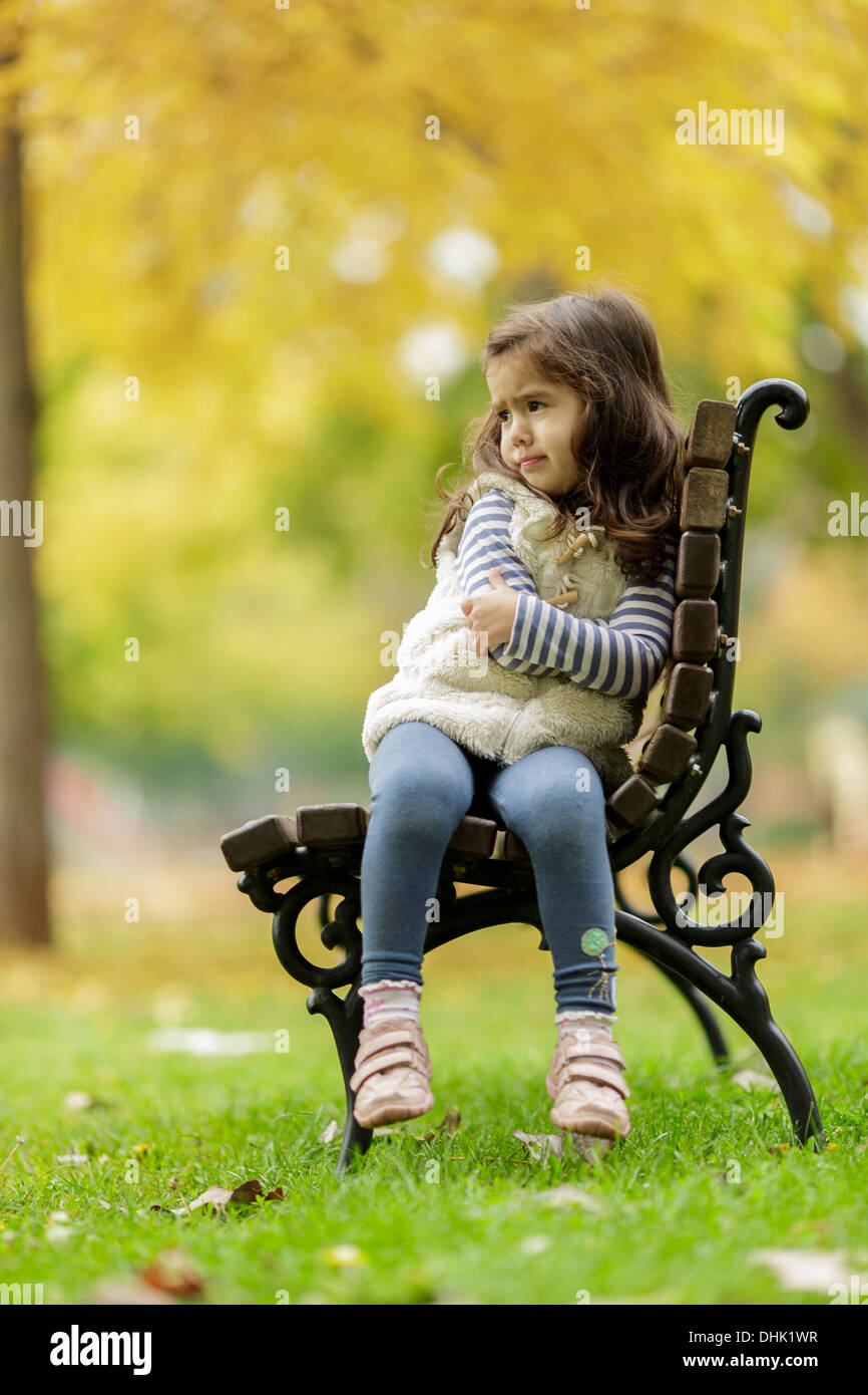 Little girl at the bench Stock Photo - Alamy