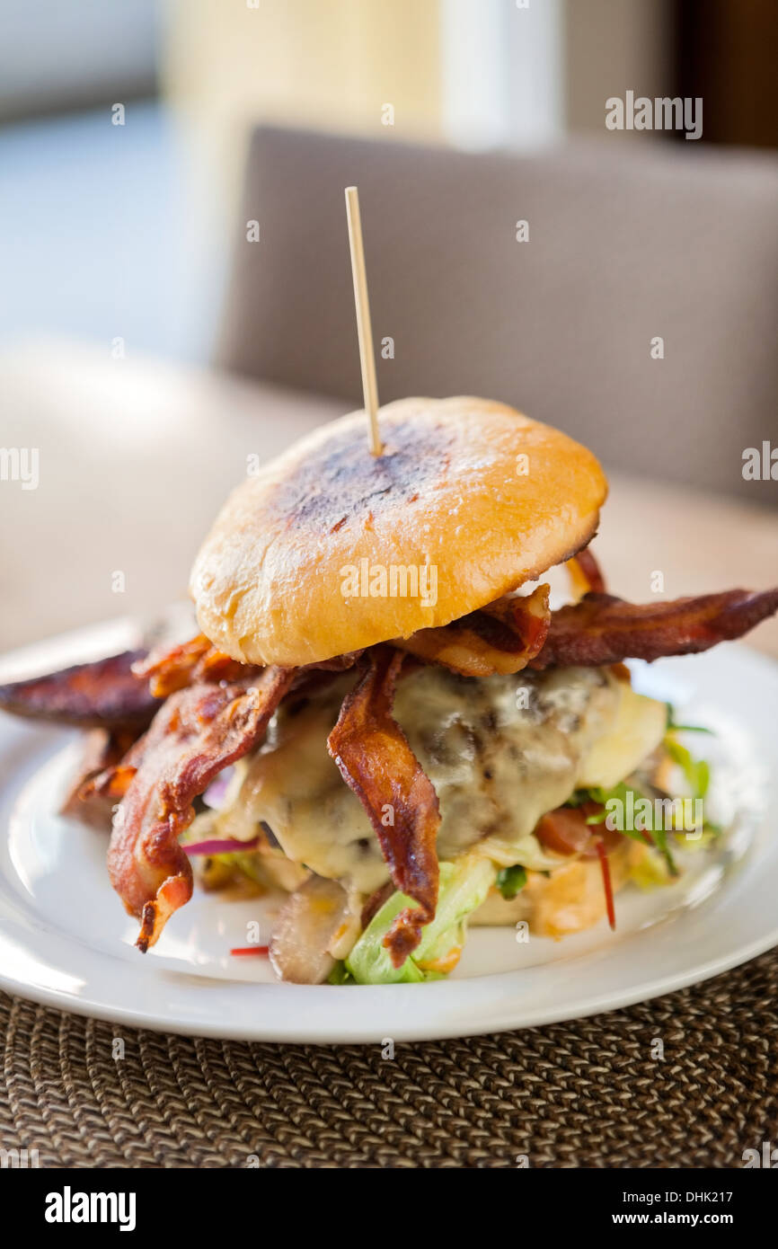 Bacon Burger on Plate in Restaurant Stock Photo - Alamy