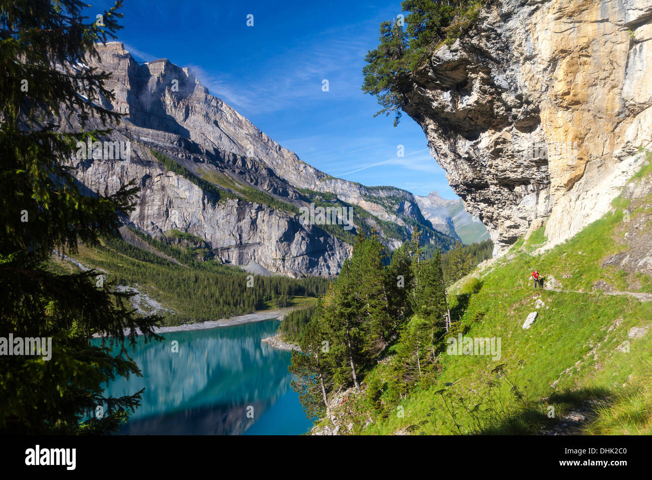 A man hiking at lake Oeschinen, Bernese Oberland, Canton of Bern ...