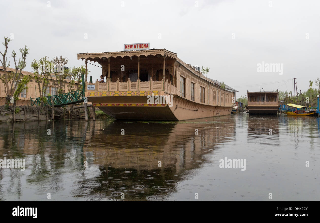 Front view of a houseboat in the Dal Lake in Srinagar with greenery to ...
