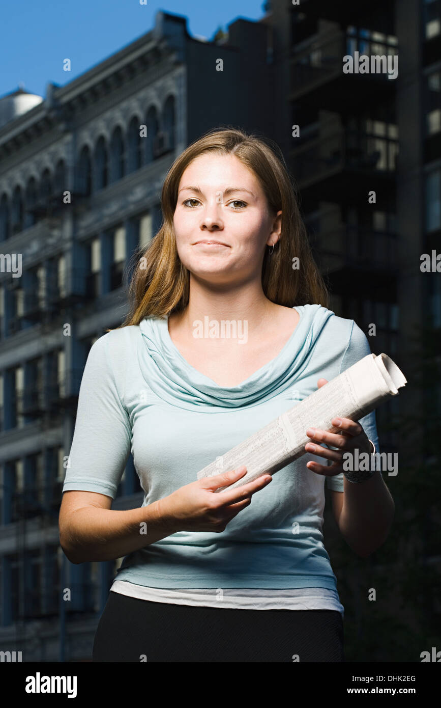 Woman holding newspaper Stock Photo - Alamy