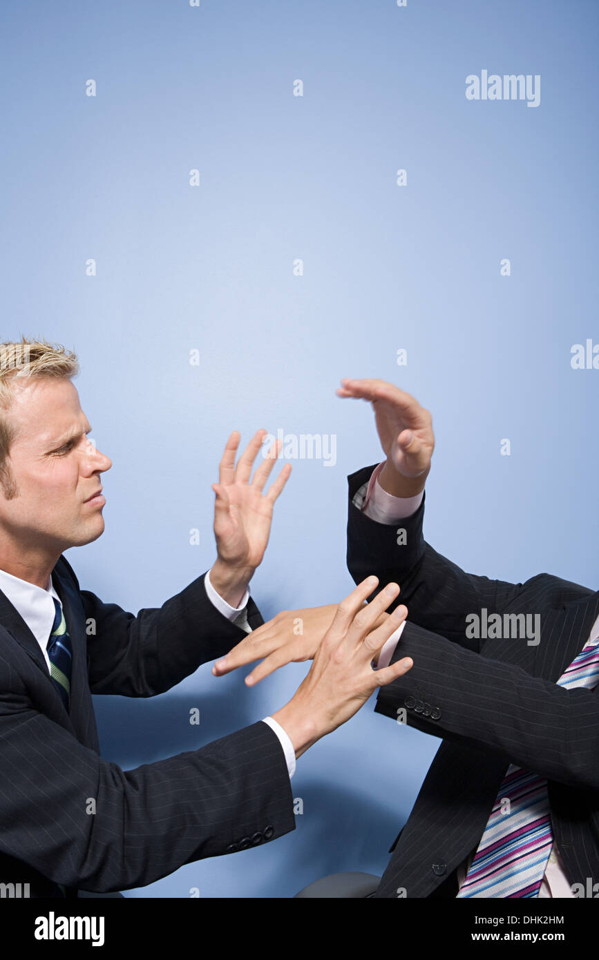 Side profile of two businessmen fighting hi-res stock photography and ...