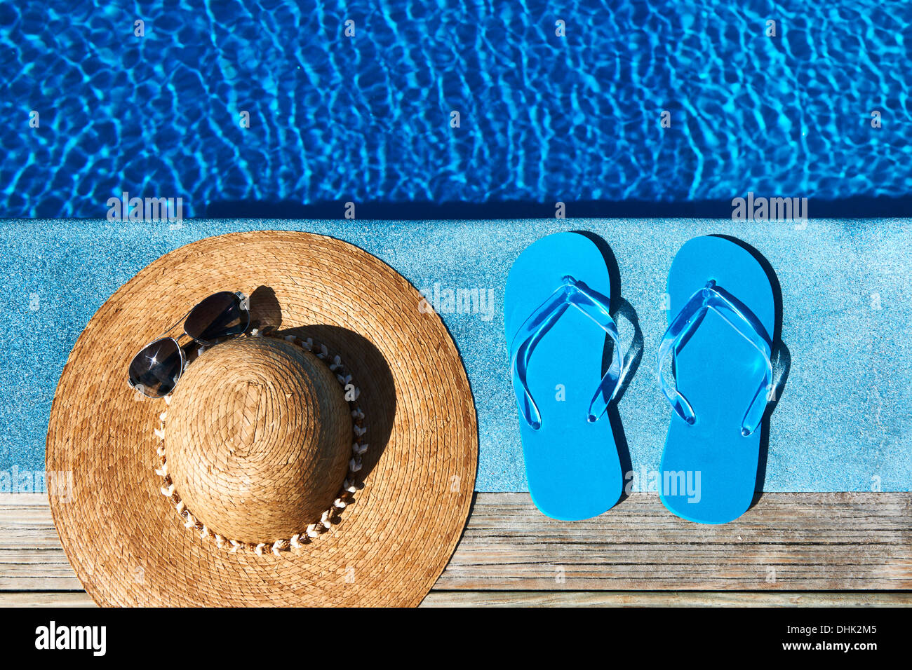 Blue slippers and hat by a swimming pool Stock Photo - Alamy