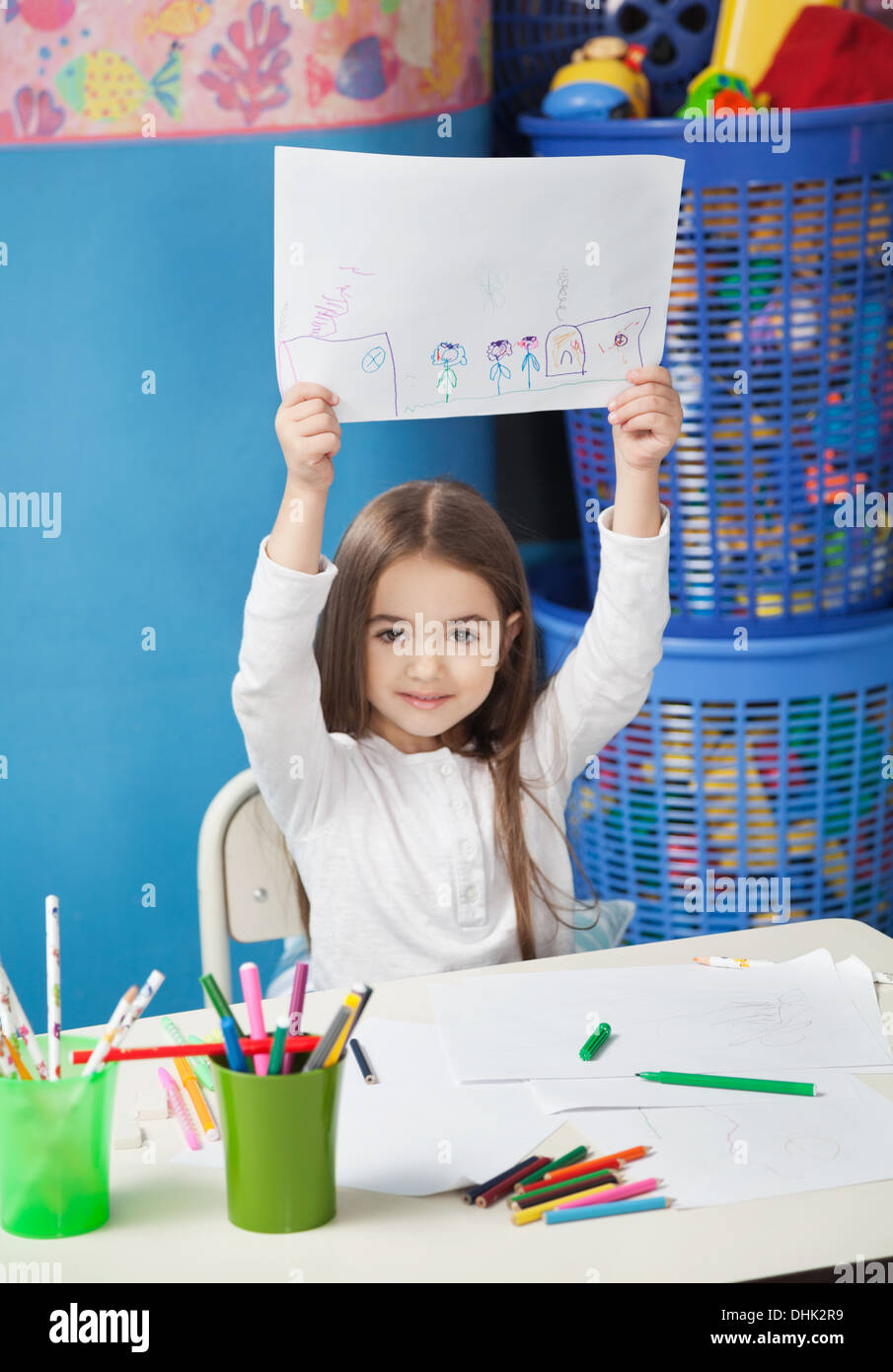 Girl Showing Drawing Paper In Art Class Stock Photo - Alamy