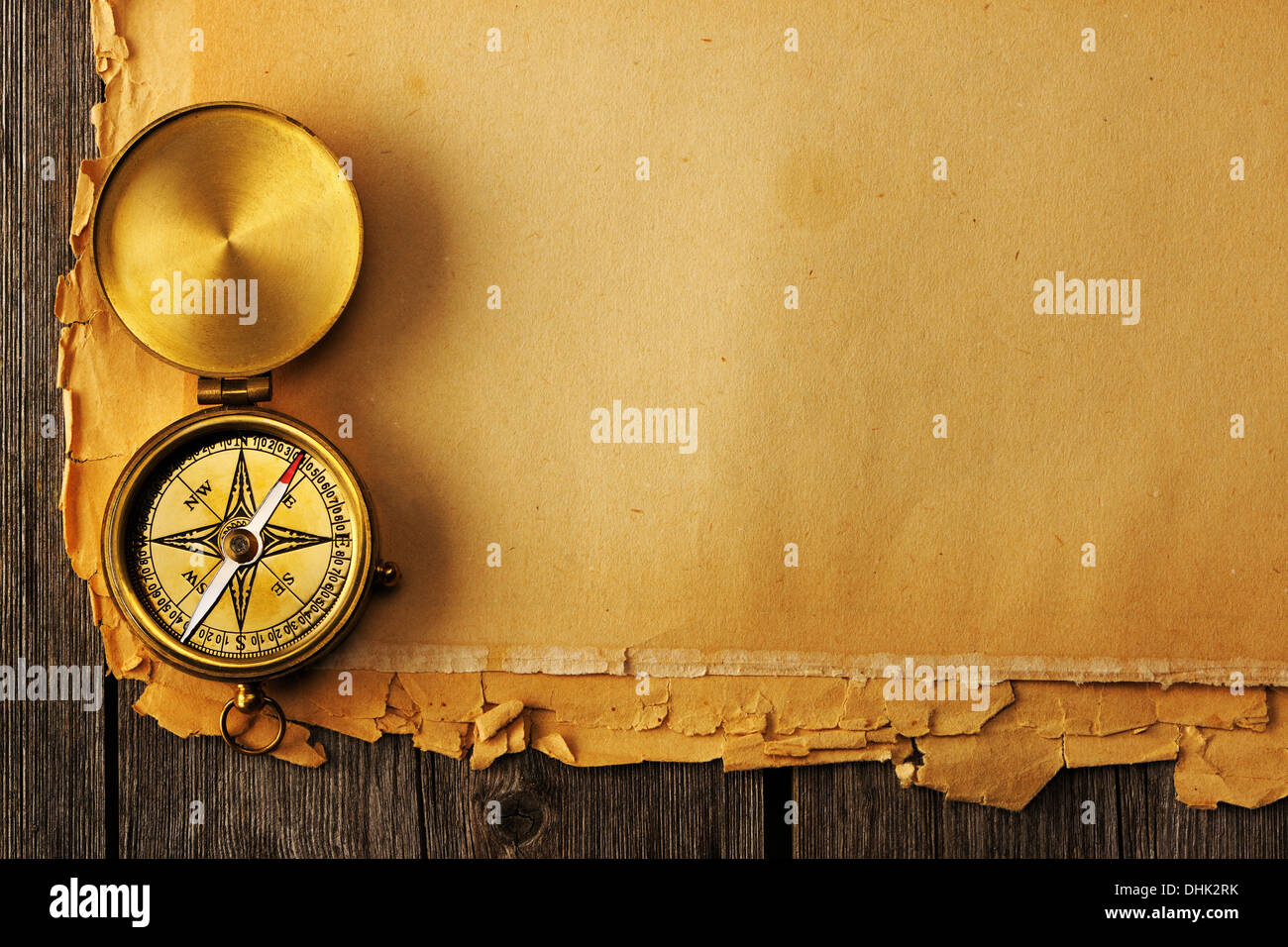 Antique brass compass over old background Stock Photo - Alamy