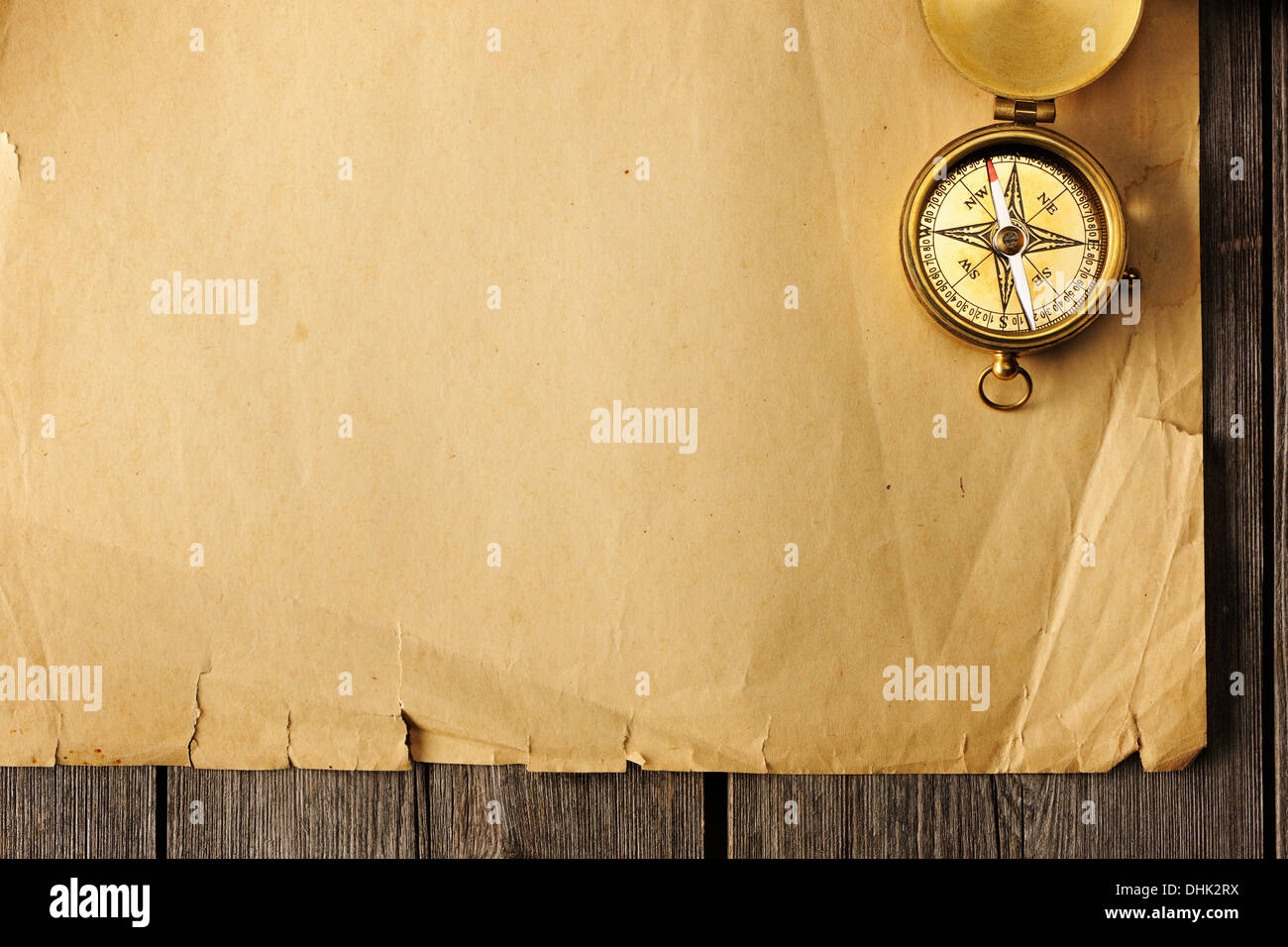 Antique brass compass over old background Stock Photo - Alamy