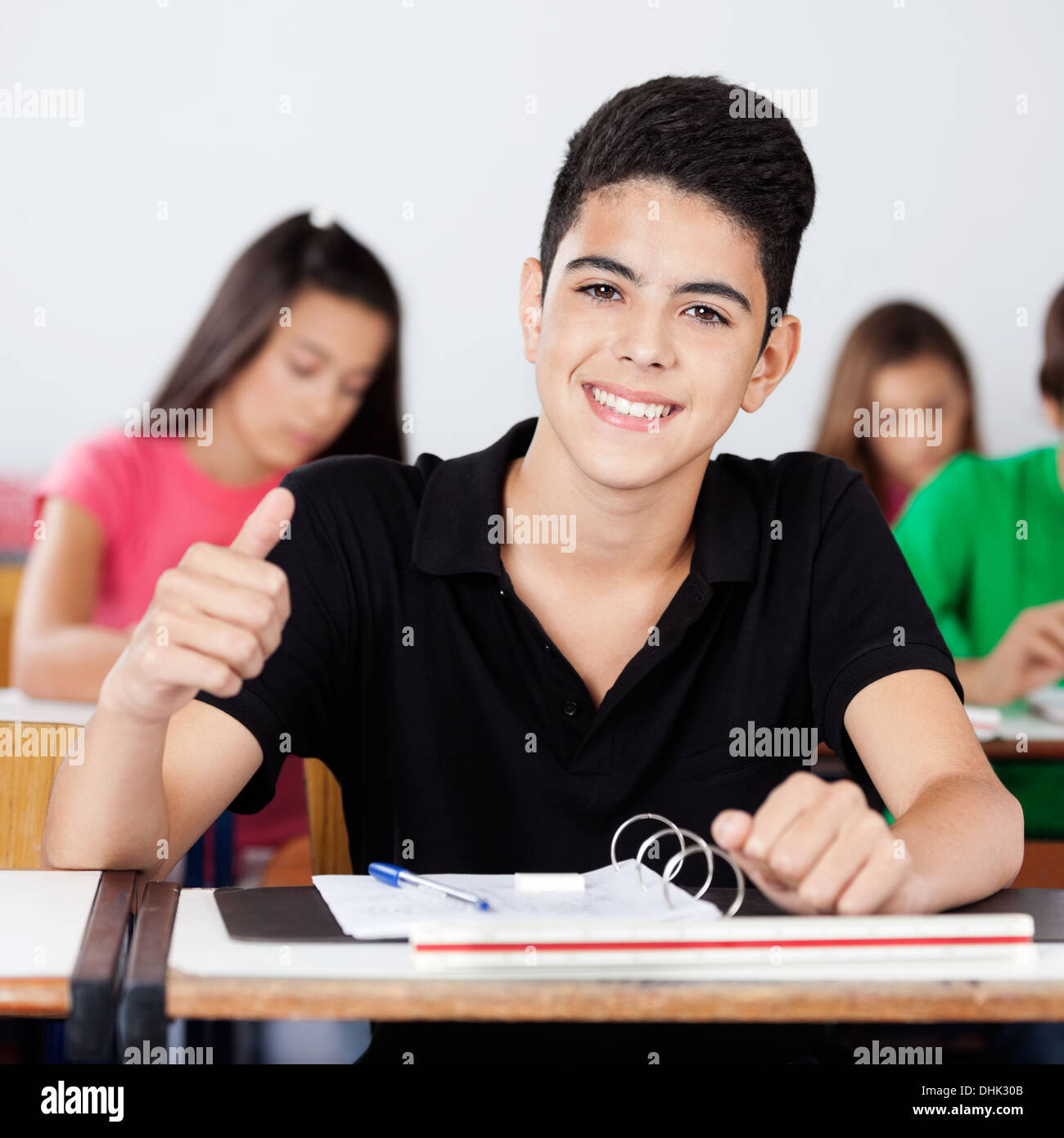 Teenage Schoolboy Gesturing Thumbs Up In Classroom Stock Photo - Alamy