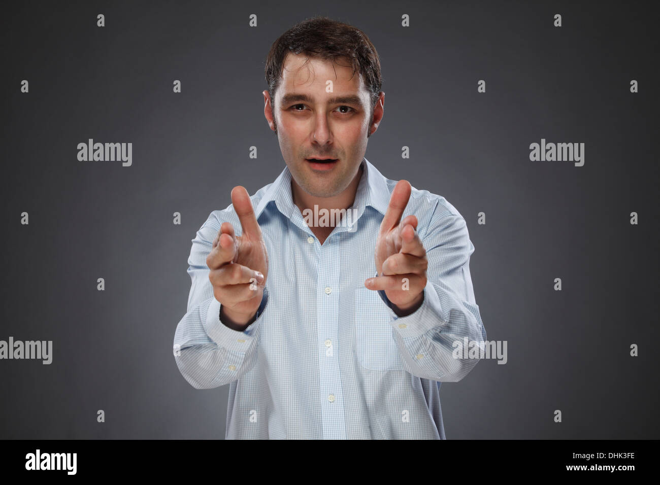 Portrait of smiling man pointing at viewer, studio shot Stock Photo - Alamy