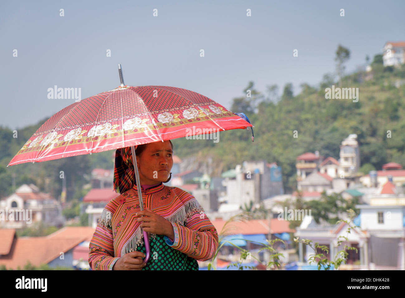 Young Flower Hmong Vietnamese women sheltering from the sun under an ...