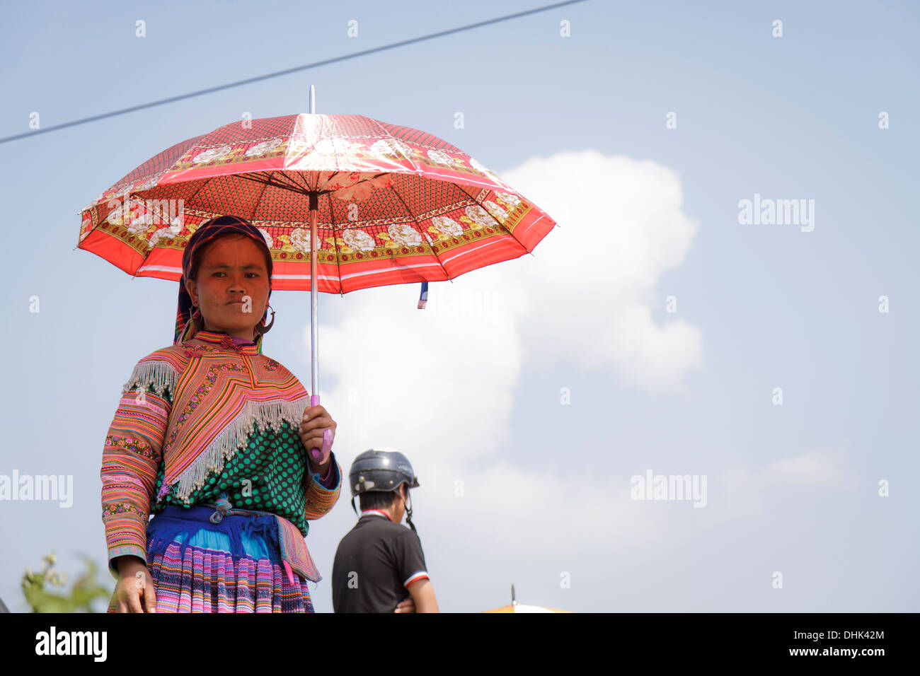 Young Flower Hmong Vietnamese women sheltering from the sun under an ...