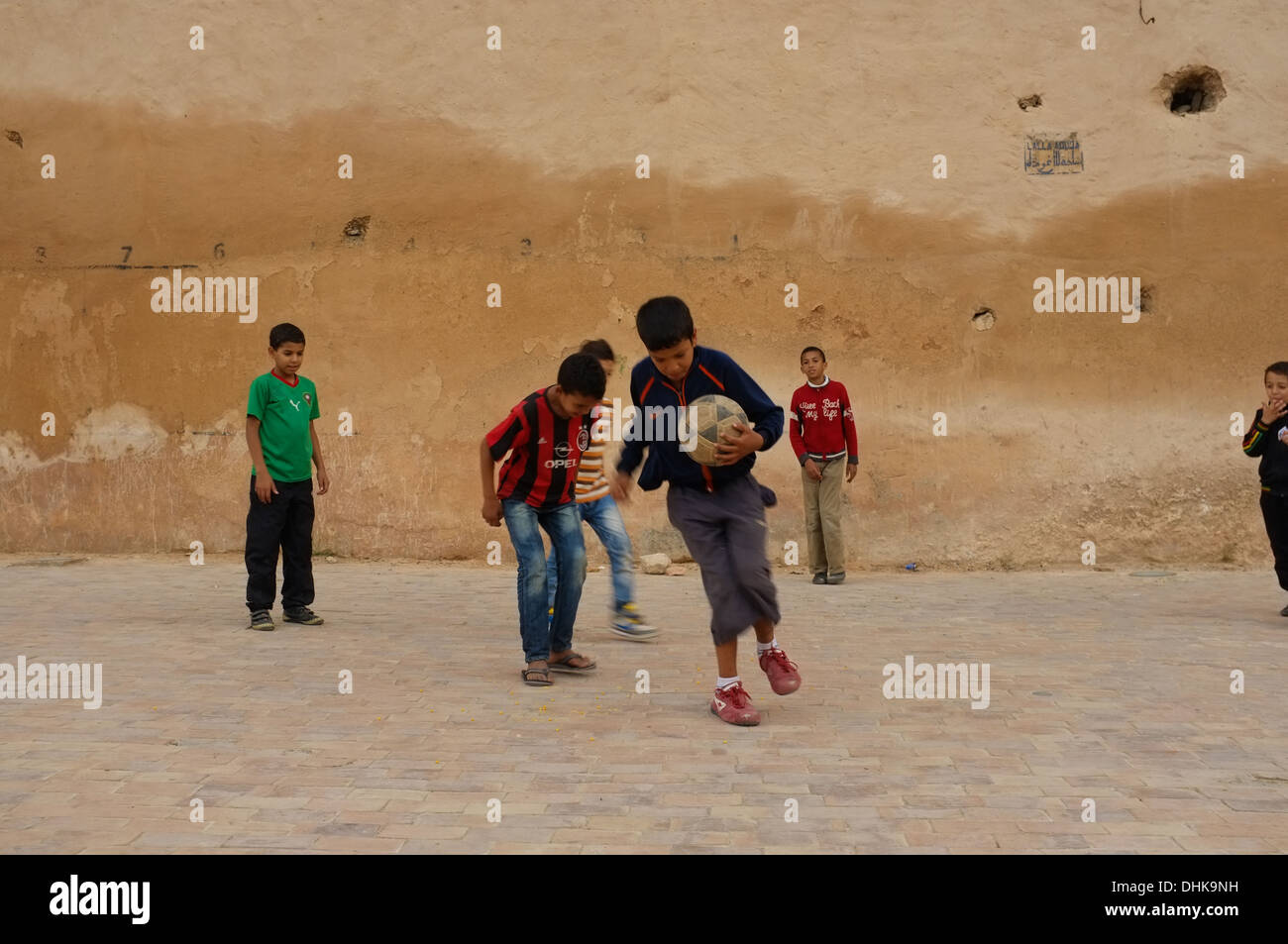 A group of young boys play football on the streets of Meknes in Morocco ...
