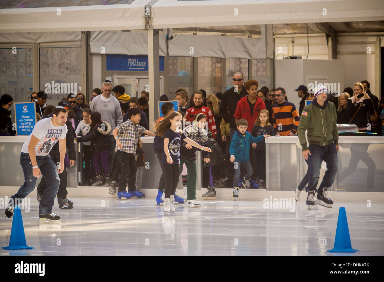 Skaters maneuver the packed Winter Village at Bryant Park ice skating ...