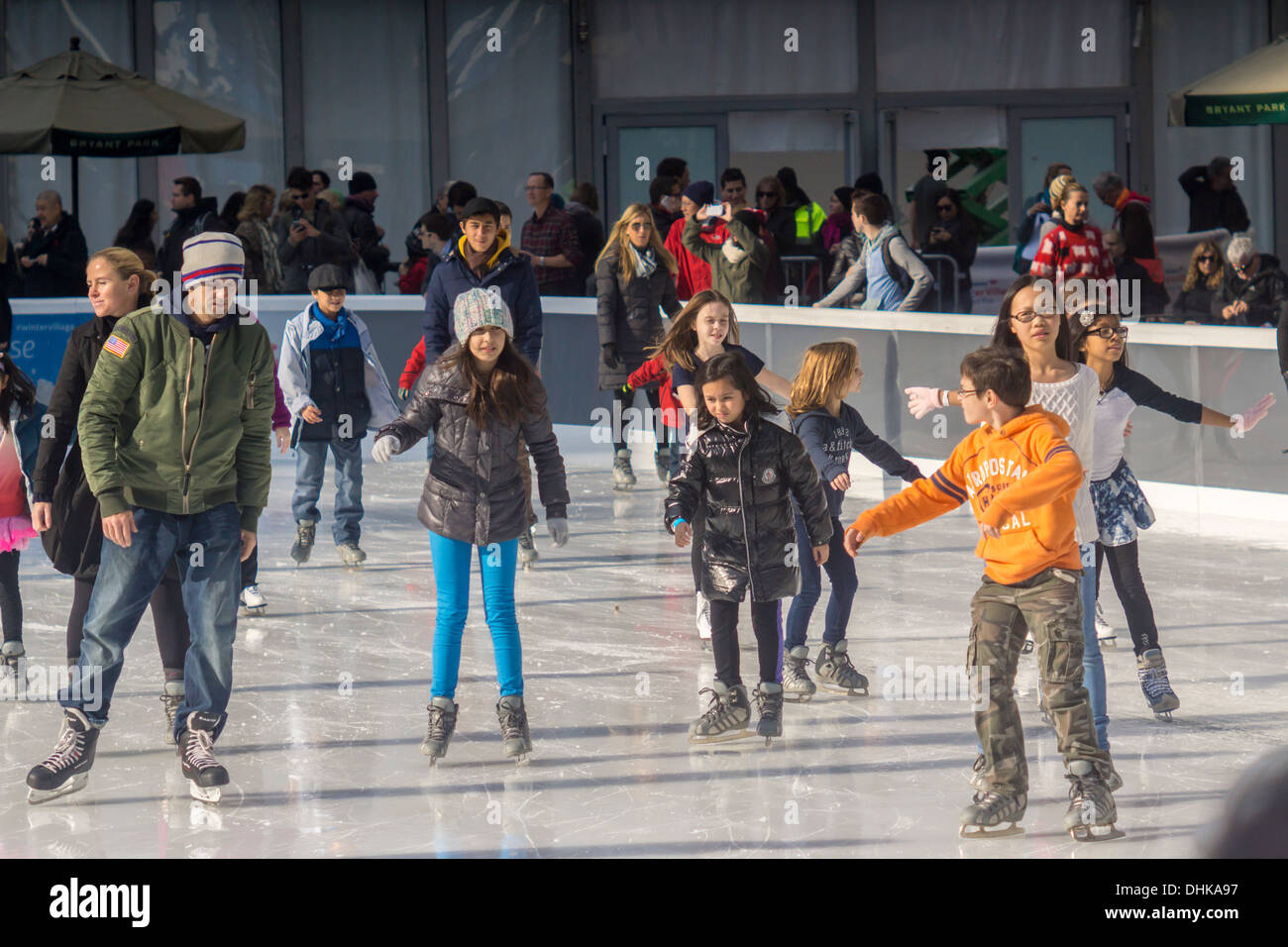 Skaters maneuver the packed Winter Village at Bryant Park ice skating ...