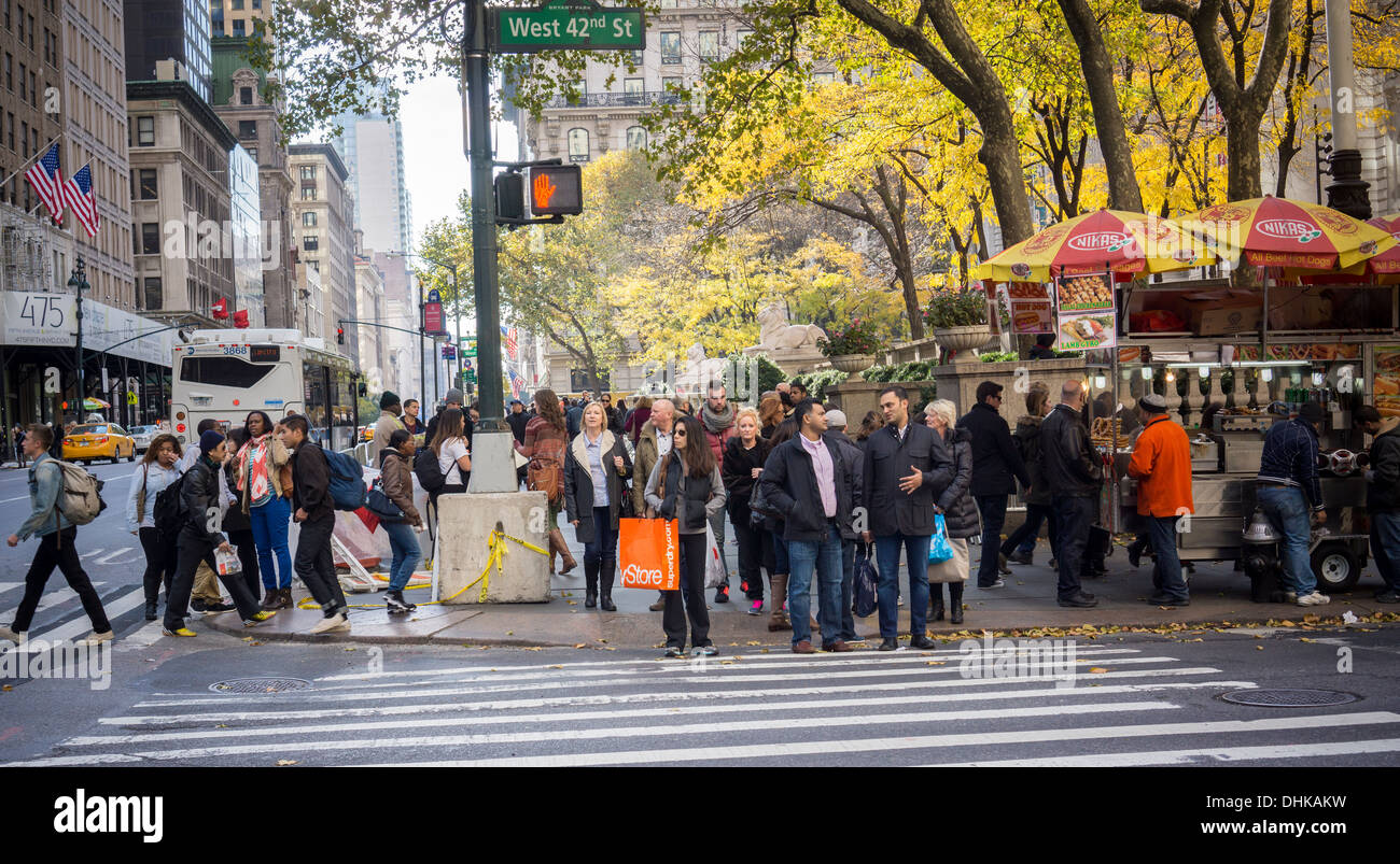 Pedestrians on Fifth Avenue in New York wait to cross 42nd Street on ...