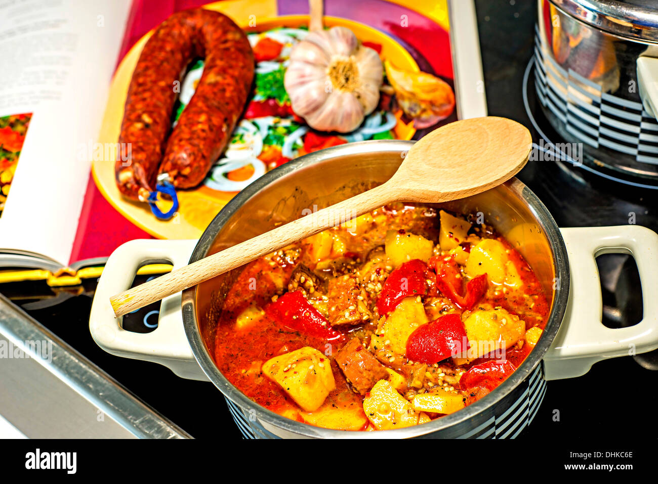 Spanish stew with chorizo sausage and textbook Stock Photo - Alamy
