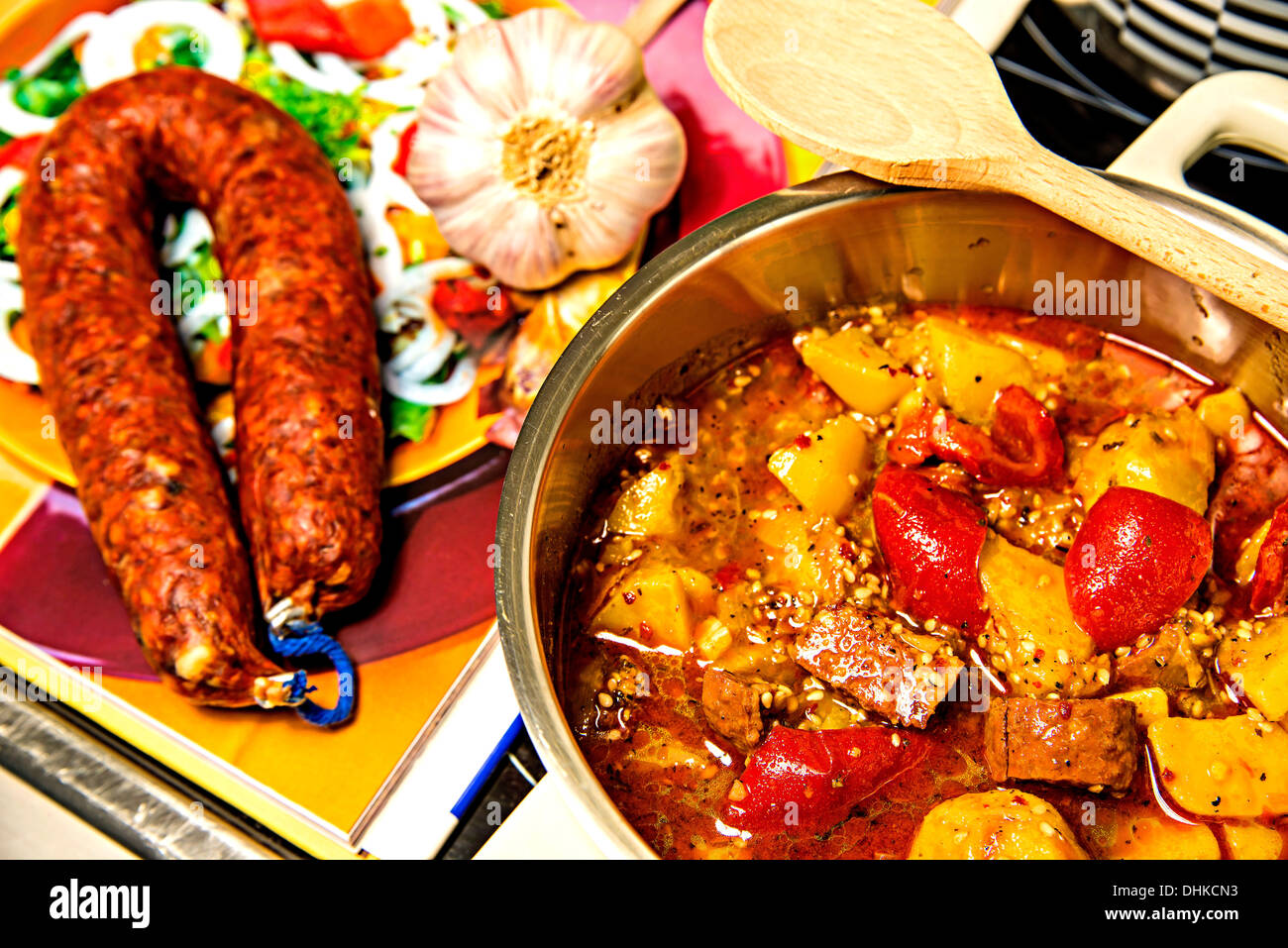 Spanish stew with chorizo sausage and textbook Stock Photo - Alamy