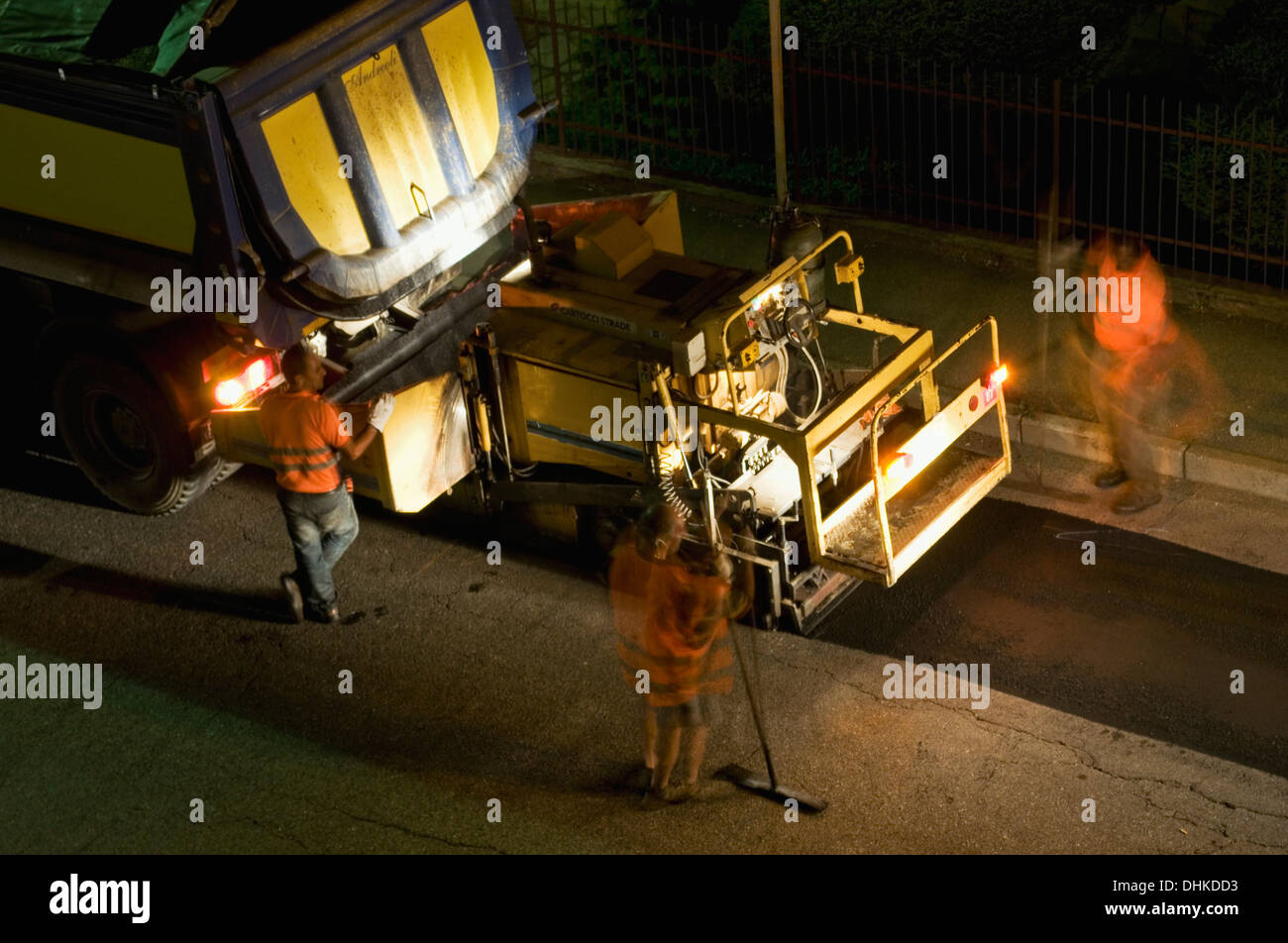 road workers at night resurfacing road Stock Photo - Alamy