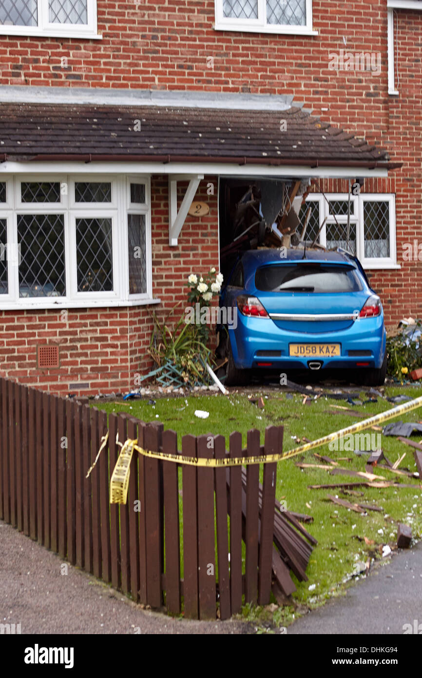 A blue car crashed into a house causing extensive damage Stock Photo ...