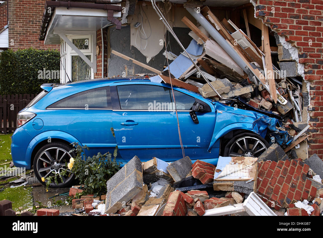 A blue car crashed into a house causing extensive damage Stock Photo ...