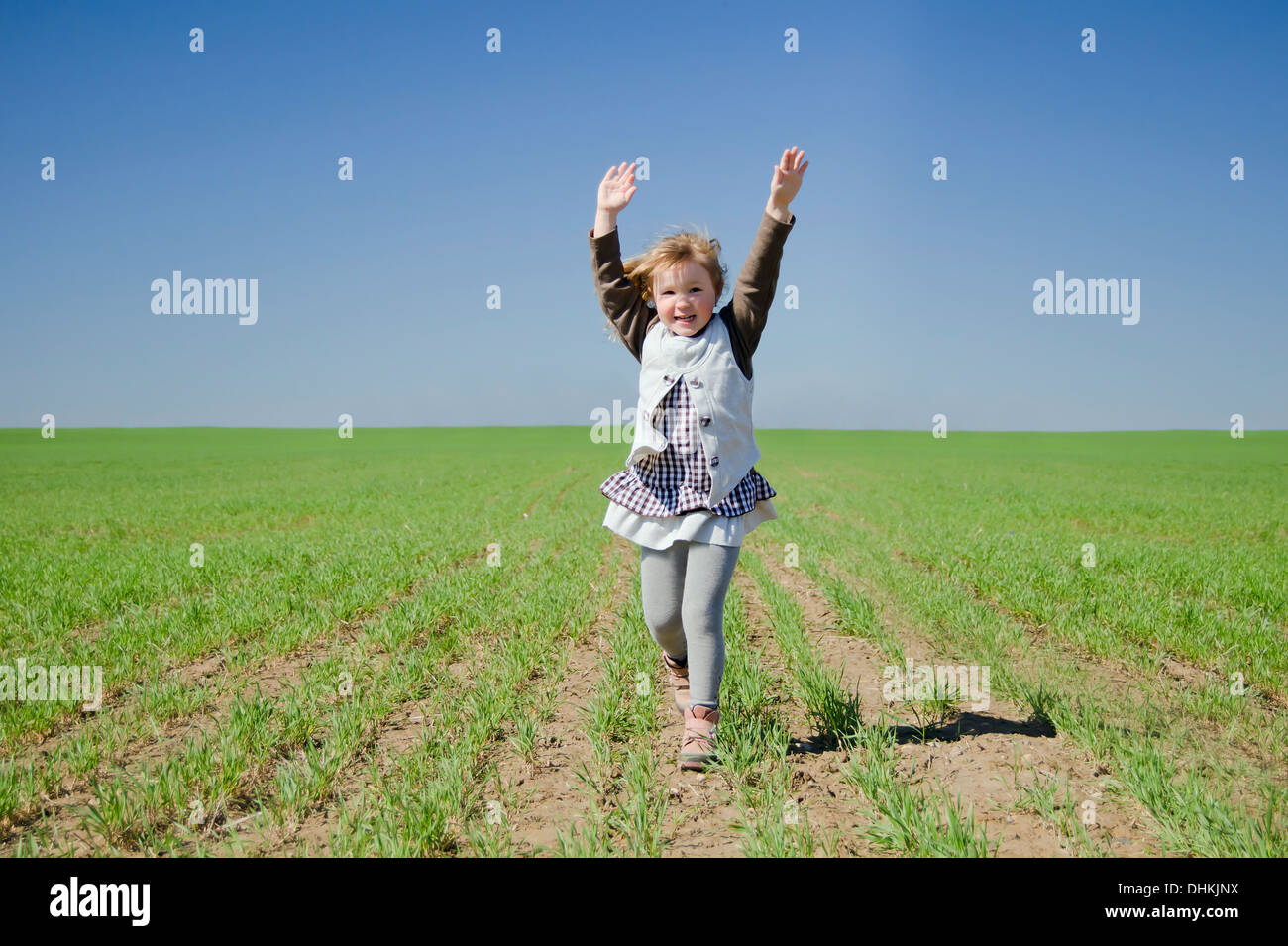 The girl runs across the field Stock Photo - Alamy