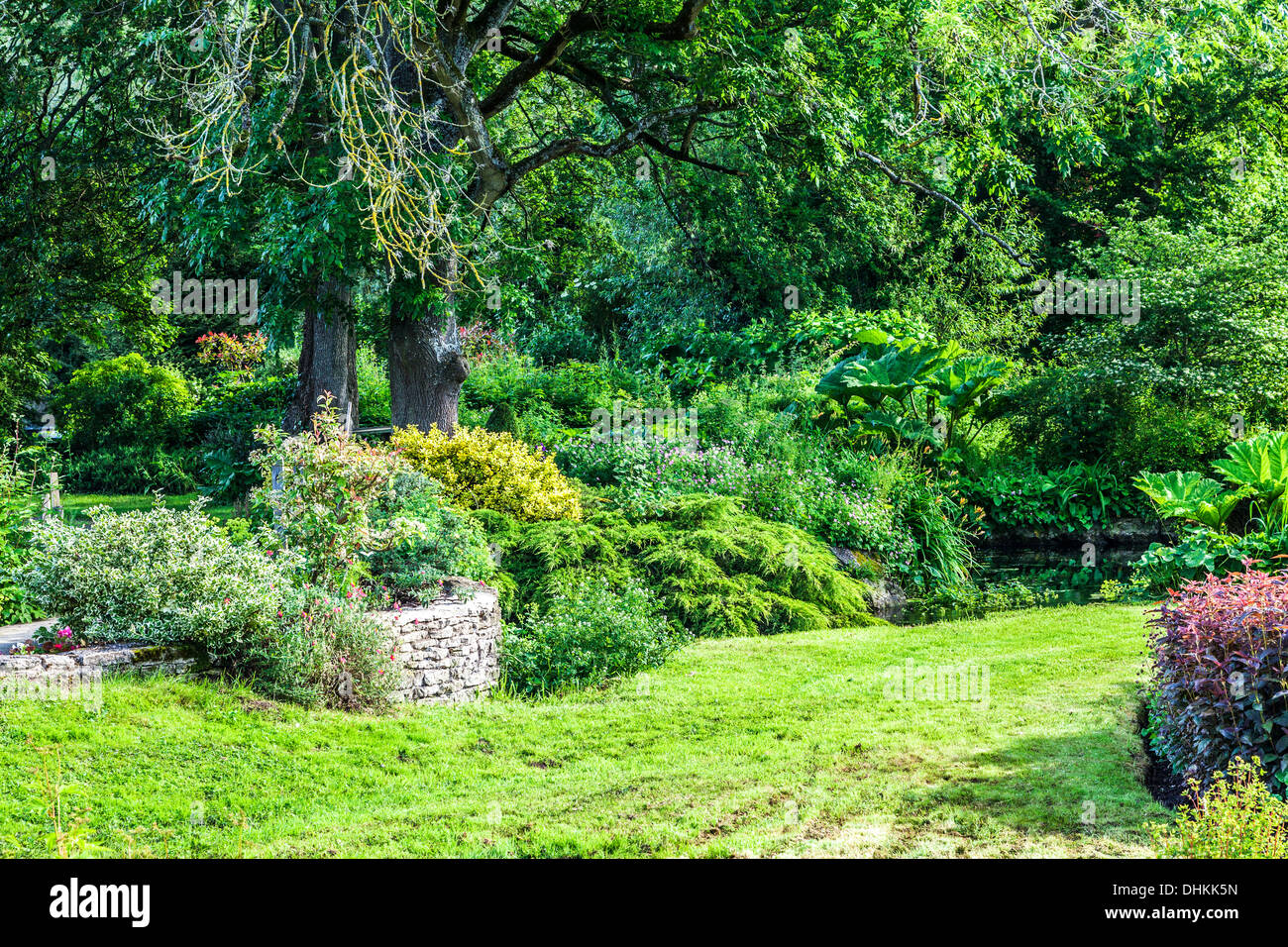 The pretty landscaped garden of the Trout Farm in the Cotswold village ...