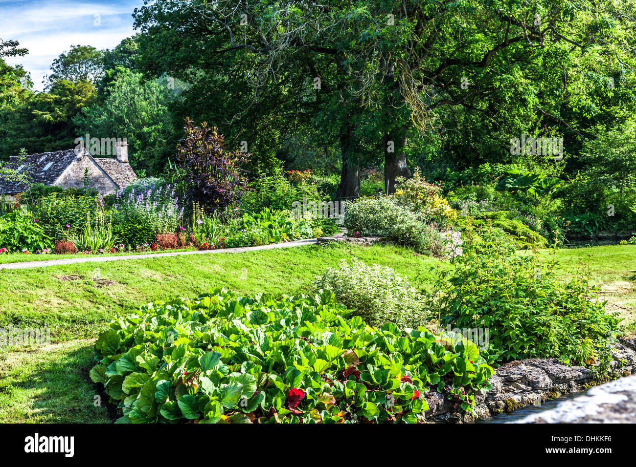 The pretty landscaped garden of the Trout Farm in the Cotswold village ...