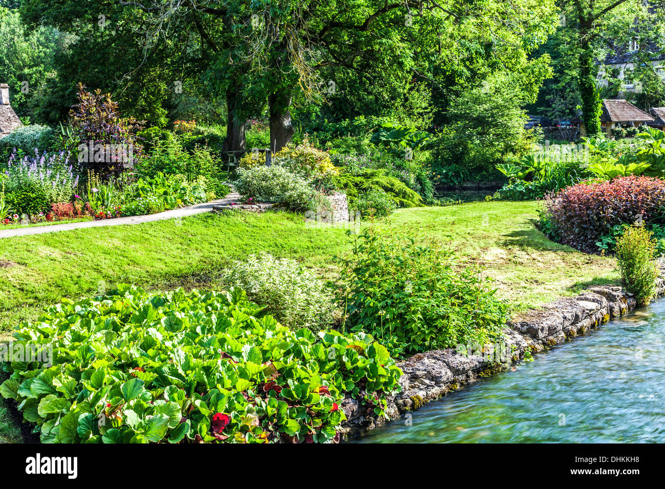 The pretty landscaped garden of the Trout Farm in the Cotswold village ...