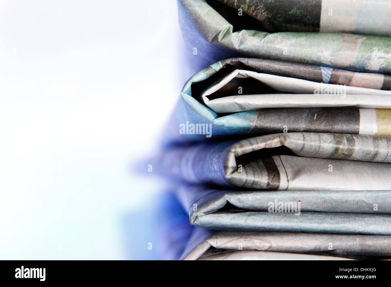 Closeup of newspapers on plain background Stock Photo - Alamy